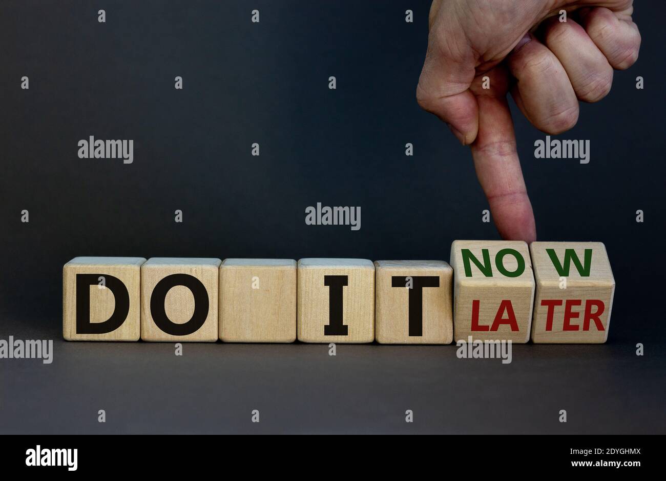 Do it now symbol. Businessman hand turns cubes and changes words 'do it ...