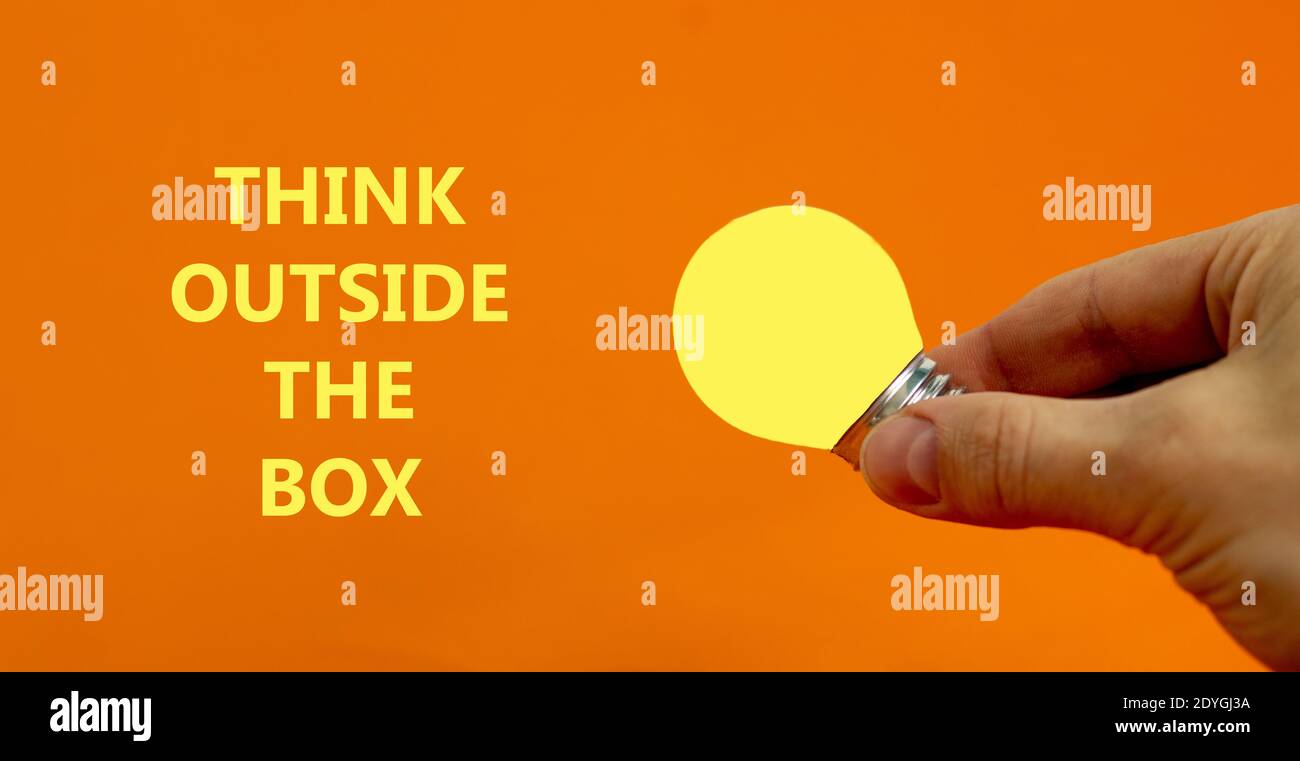 Think outside the box symbol. Businessman hand holding light bulb ...