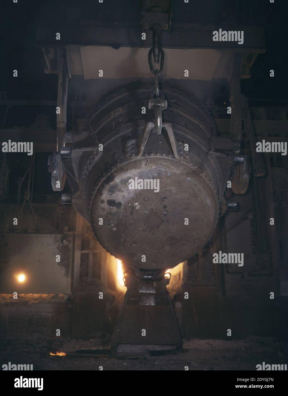 Ladle of molten iron is poured into an open hearth furnace for ...
