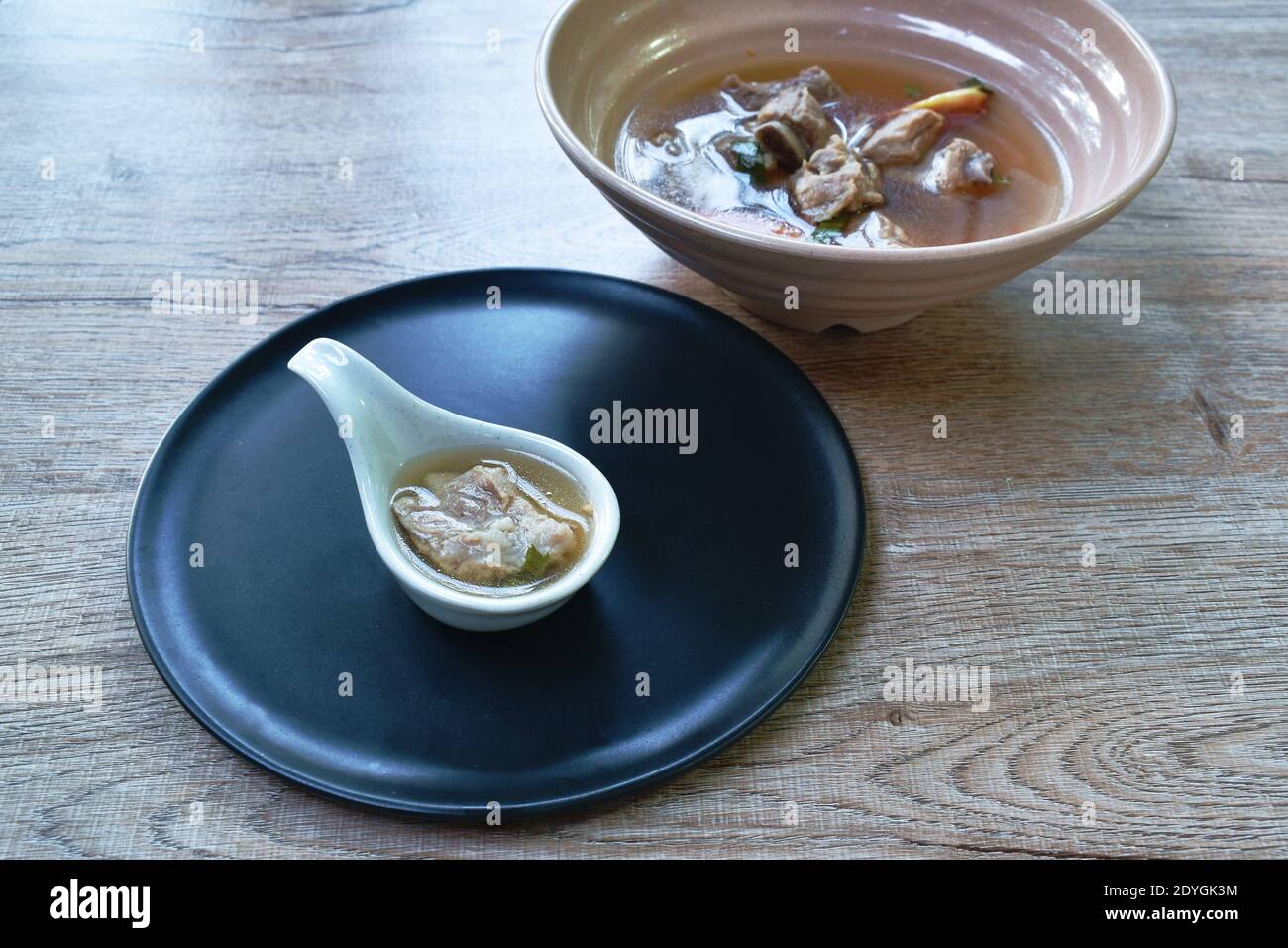 hot and spicy pork bone with tomato in Thai tom yum soup on spoon Stock ...