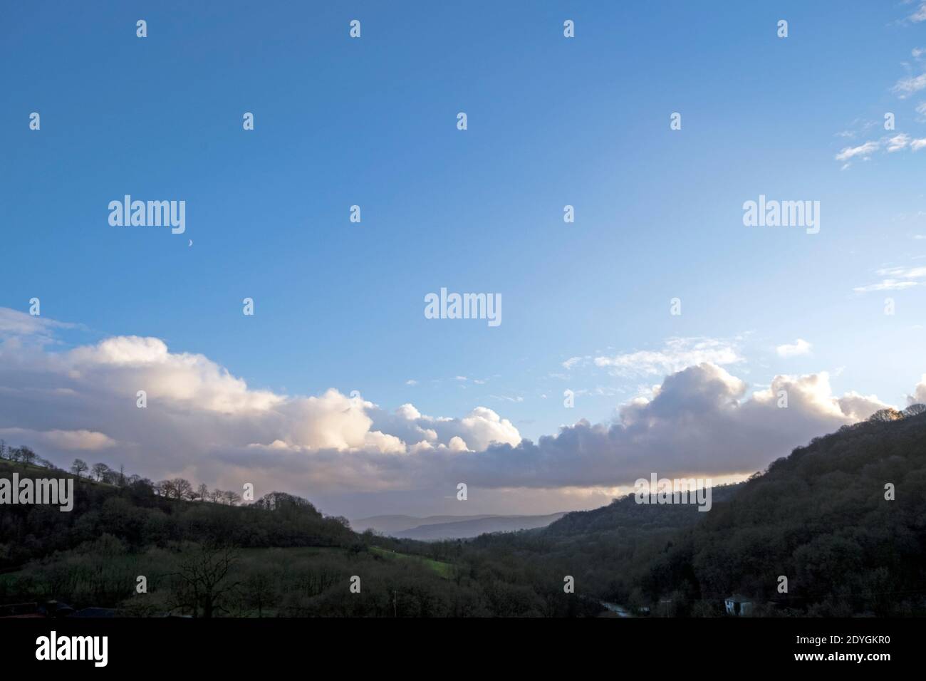 Blue sky with copy space cumulous clouds on horizon Welsh hills ...
