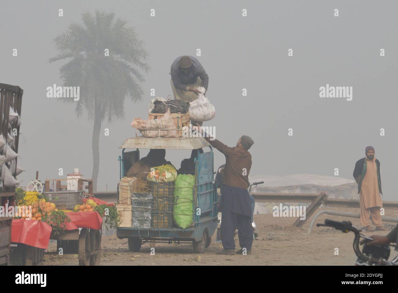 Pakistani Commuters make their way amid dense fog on a cold winter in ...