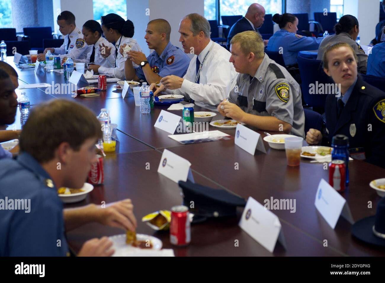 Law enforcement explorers from various agencies seated around a table ...