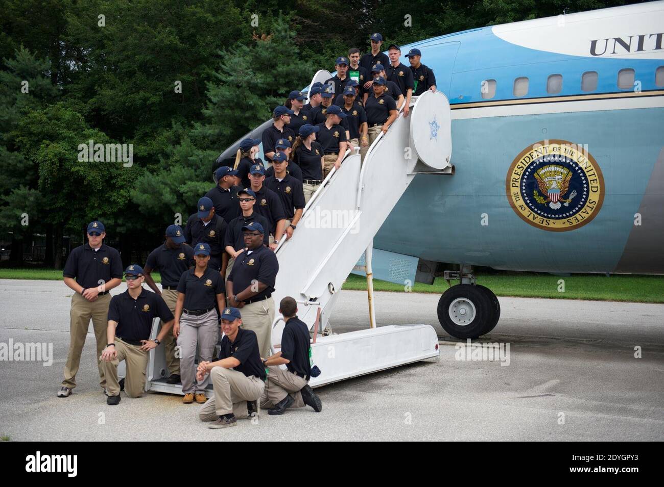 Law enforcement explorers aboard stairs to plane 2 Stock Photo - Alamy