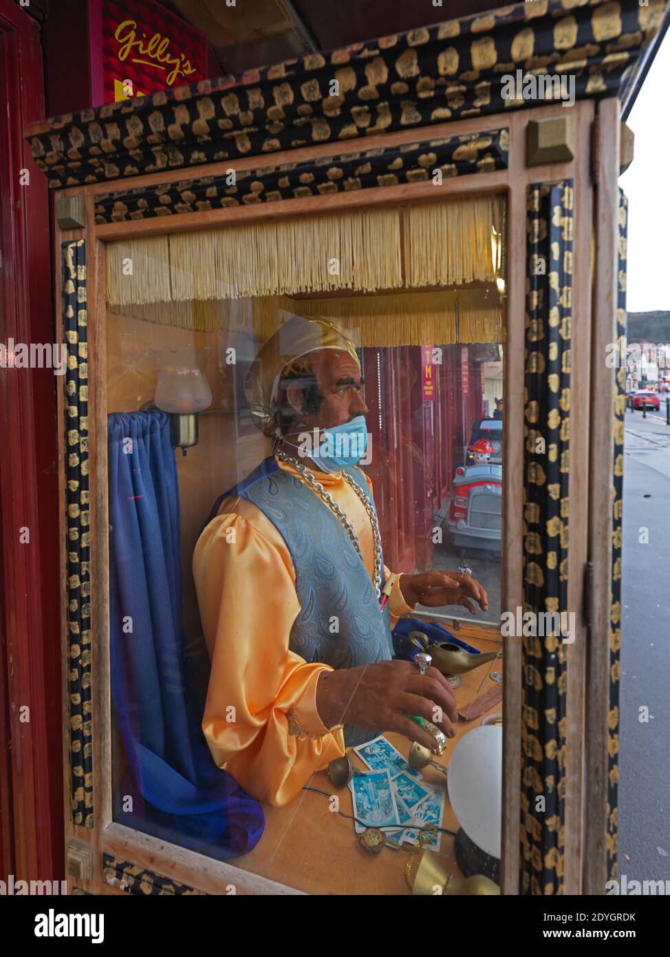 A fortune telling amusment arcade figure wearing a slipped face mask at ...