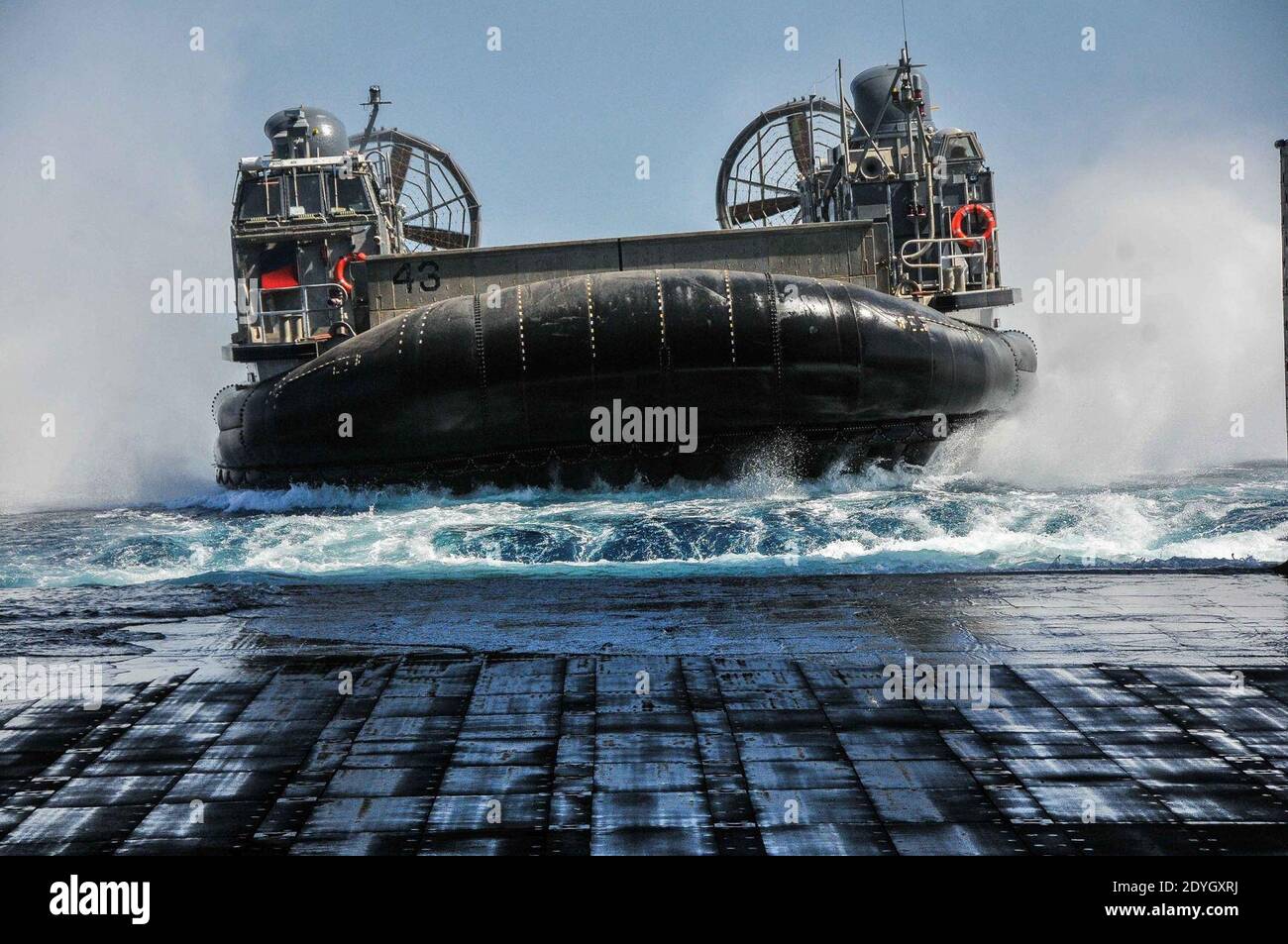 Landing Craft Air Cushion (LCAC) enters the well deck of the USS New ...
