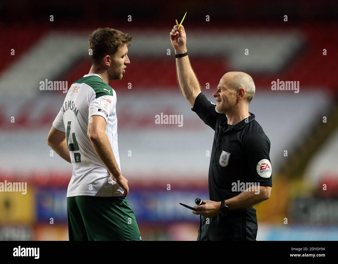 Plymouth Argyle's Will Aimson is shown a yellow card by referee Andy ...