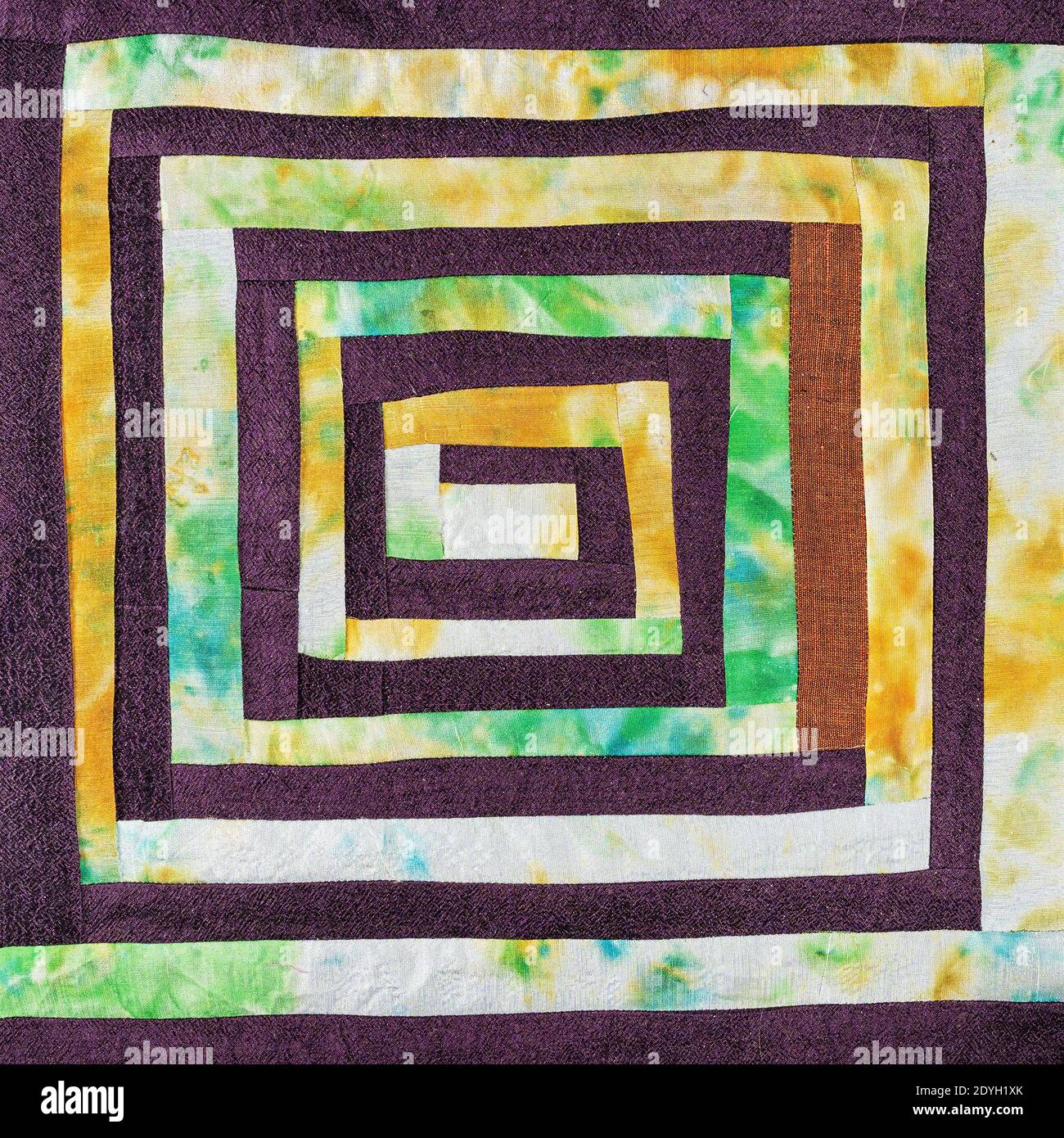 textile background - stitched detail of patchwork fabric with yellow ...