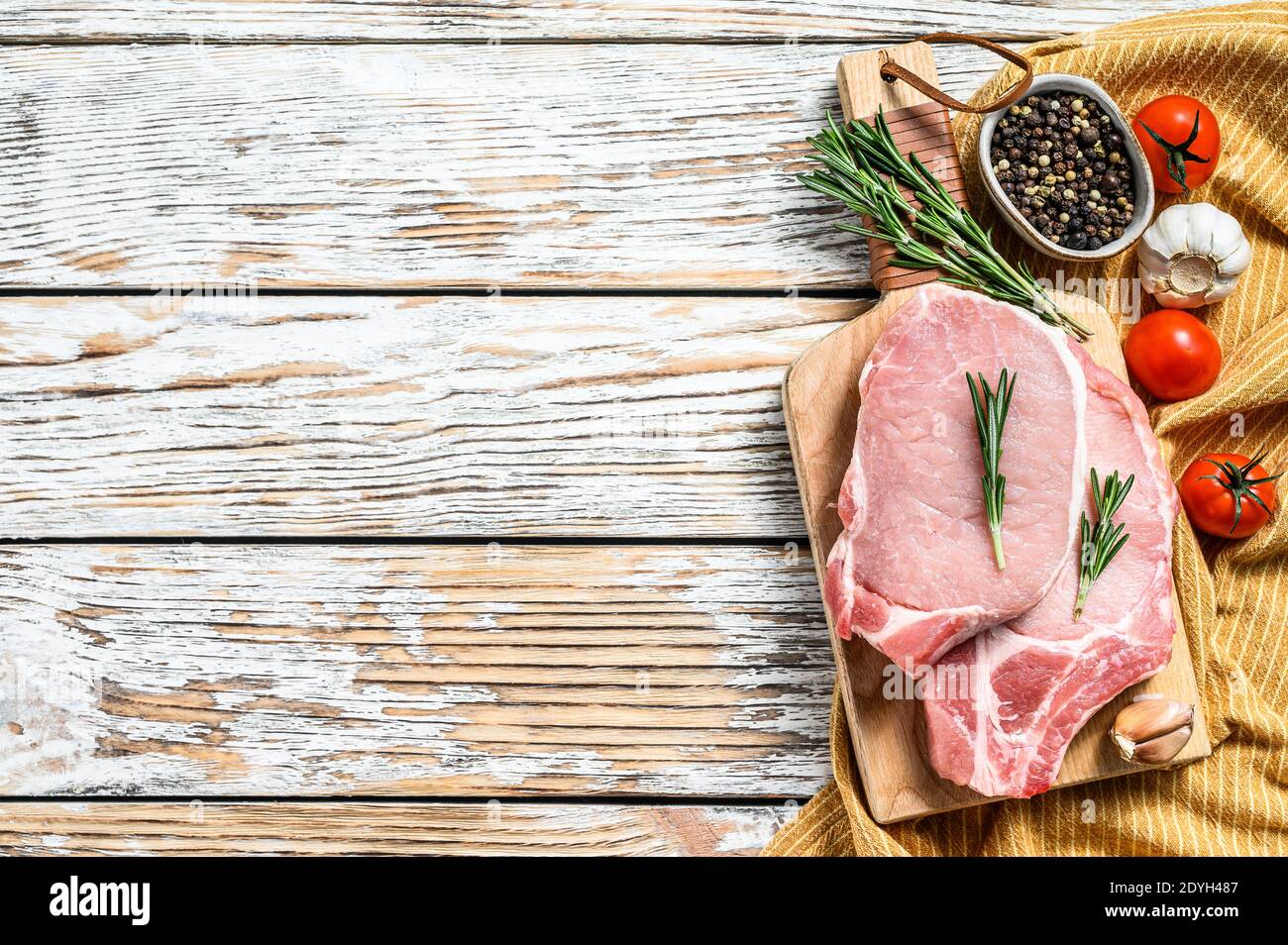 Raw pork cutlet. Organic meat steak. White background. Top view. Copy ...