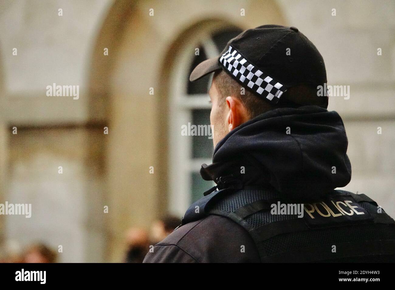 Headshot of armed metropolitan police officer standing guarding at ...