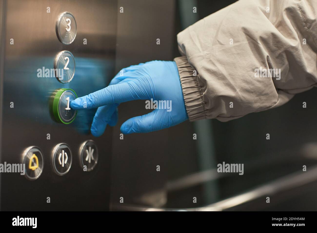 Woman pushing elevator button hi-res stock photography and images - Alamy