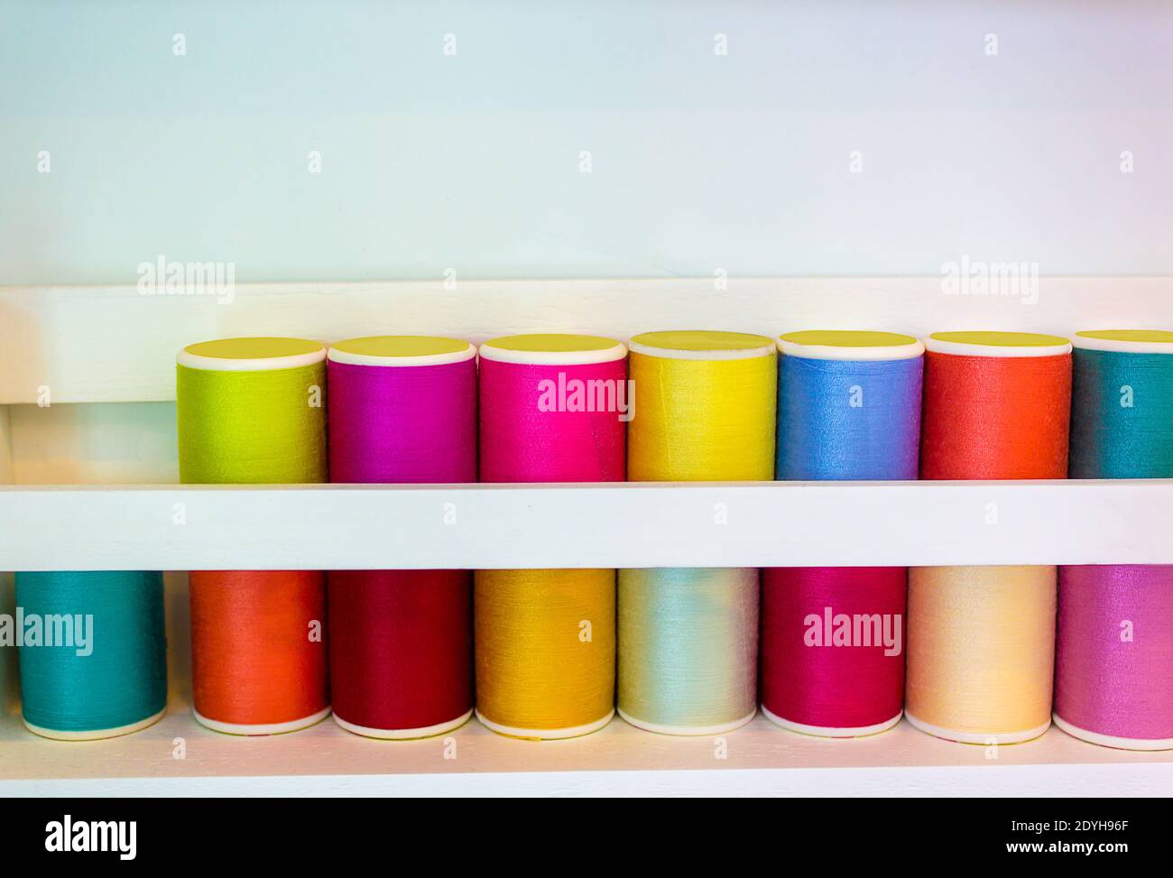 Colorful thread spools used in fabric and textile industry with copy ...