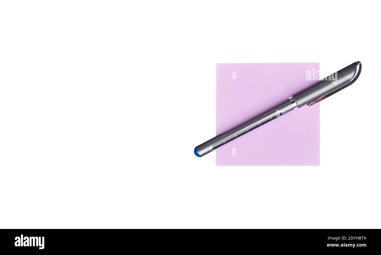 Pen lying on a sticker note, isolated on white background, with copy ...