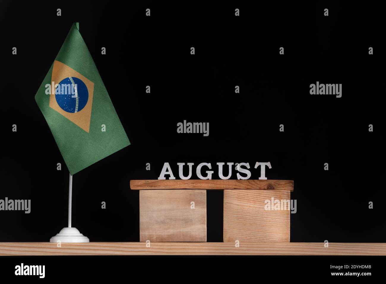 Wooden calendar of August with Brazilian flag on black background ...