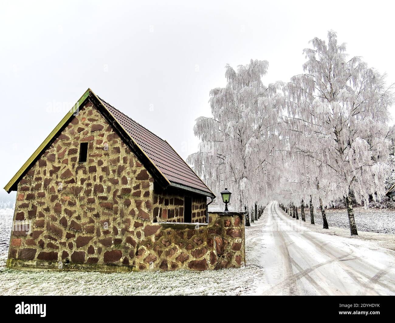 Beautiful winter landscape with empty road small house and snow covered ...