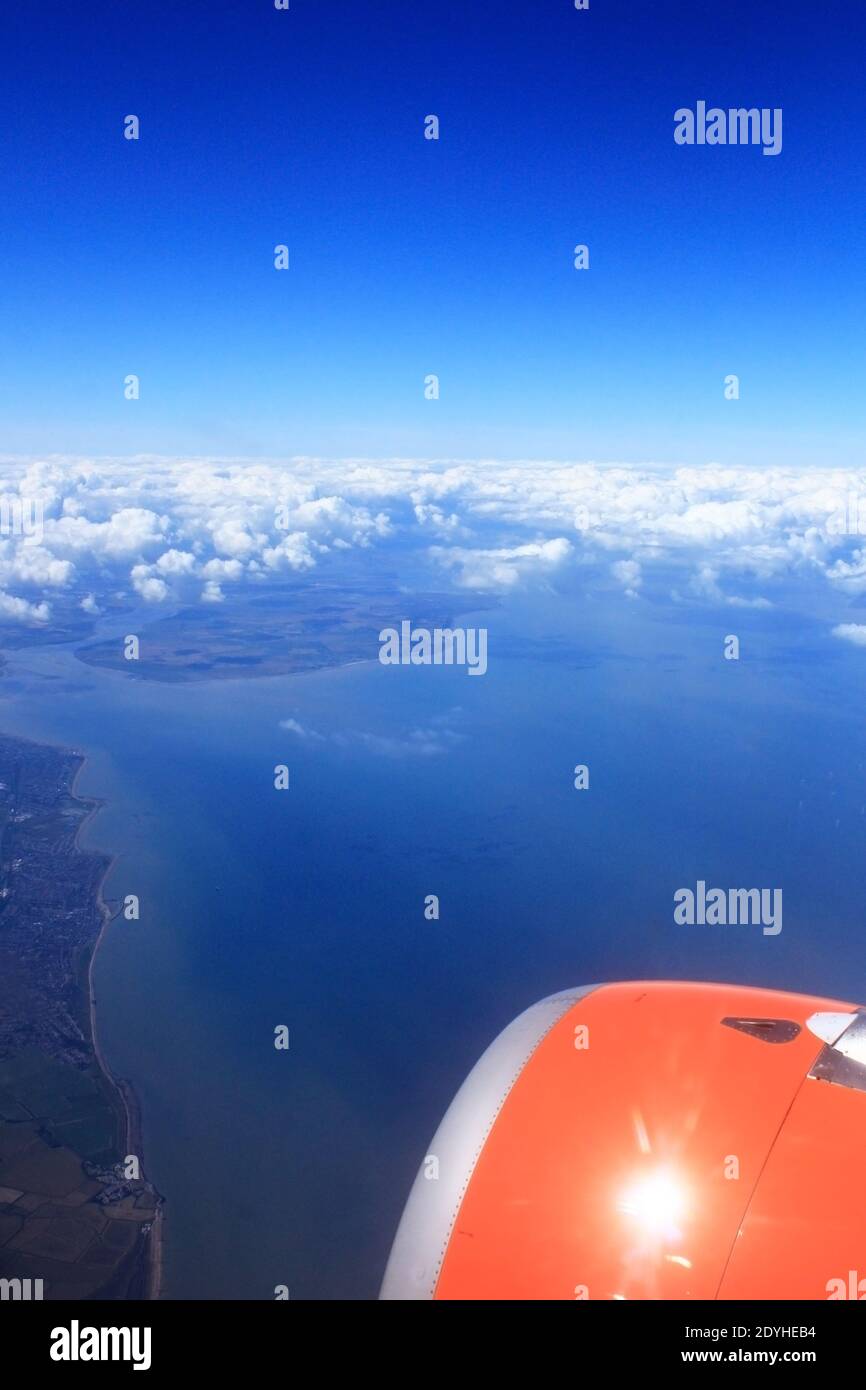 Flying airplane over the clouds above Kent coast,English Channel ...