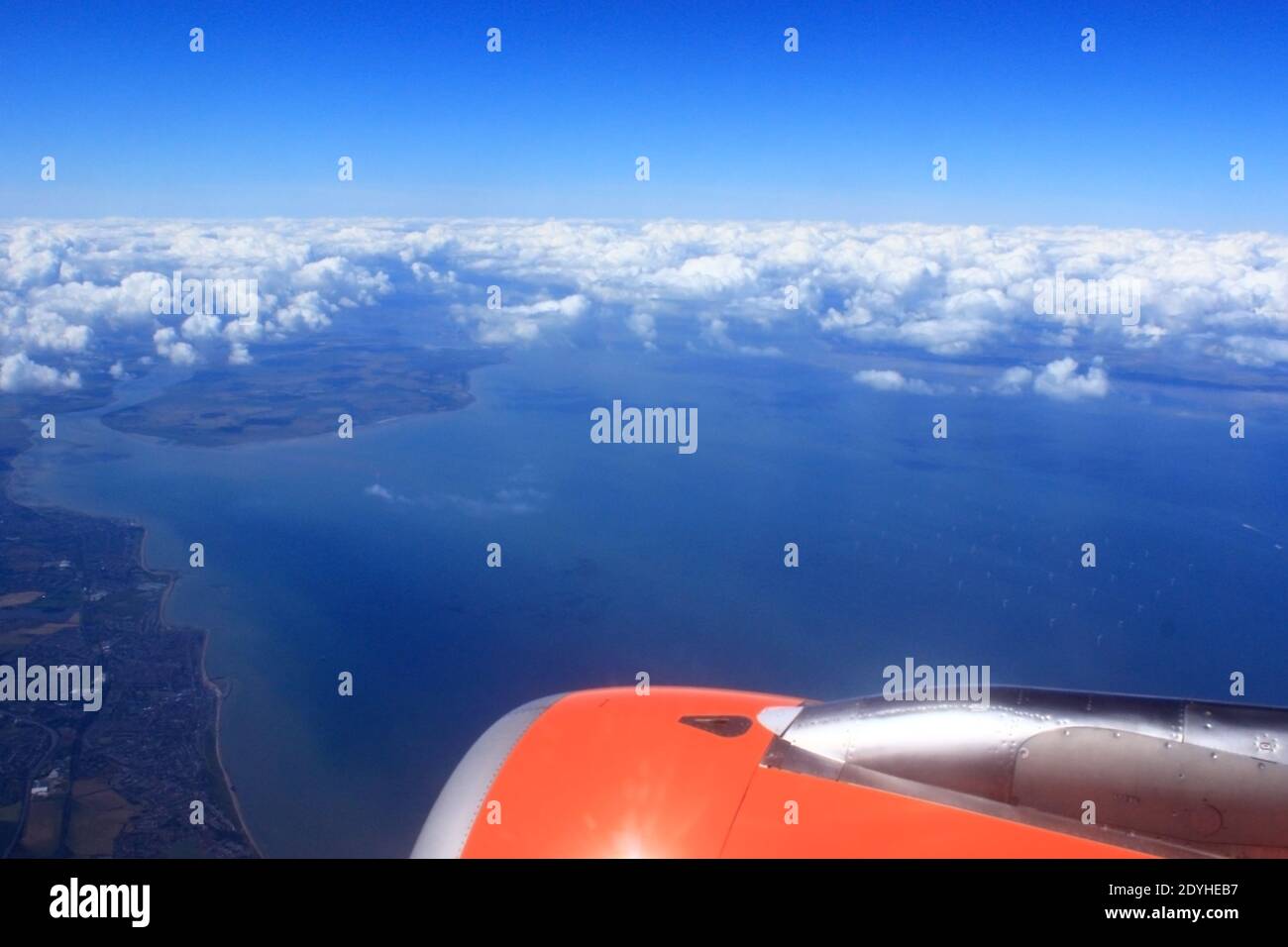 Flying airplane over the clouds above Kent coast,English Channel ...