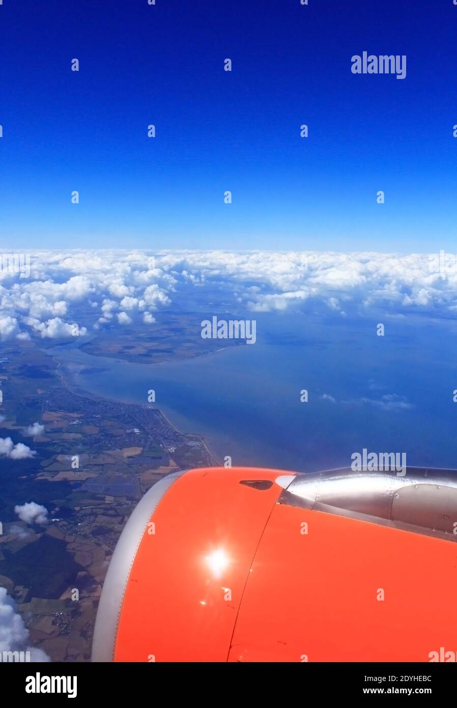 Flying airplane over the clouds above Kent coast,English Channel ...