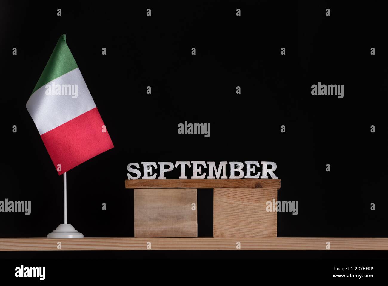 Wooden calendar of September with Italian flag on black background ...