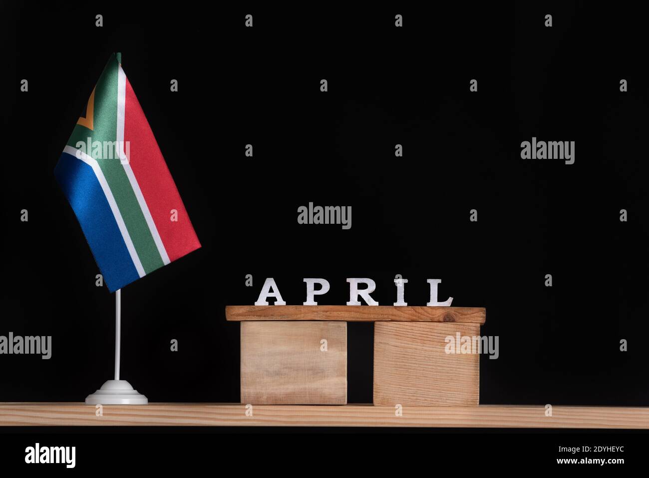 Wooden calendar of April with RSA flag on black background. Dates of ...