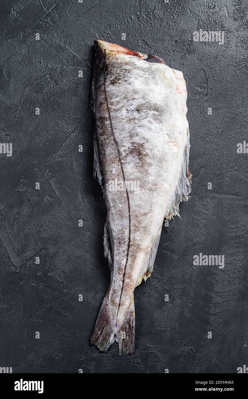 Raw haddock fish without a head. Black background. Top view Stock Photo ...