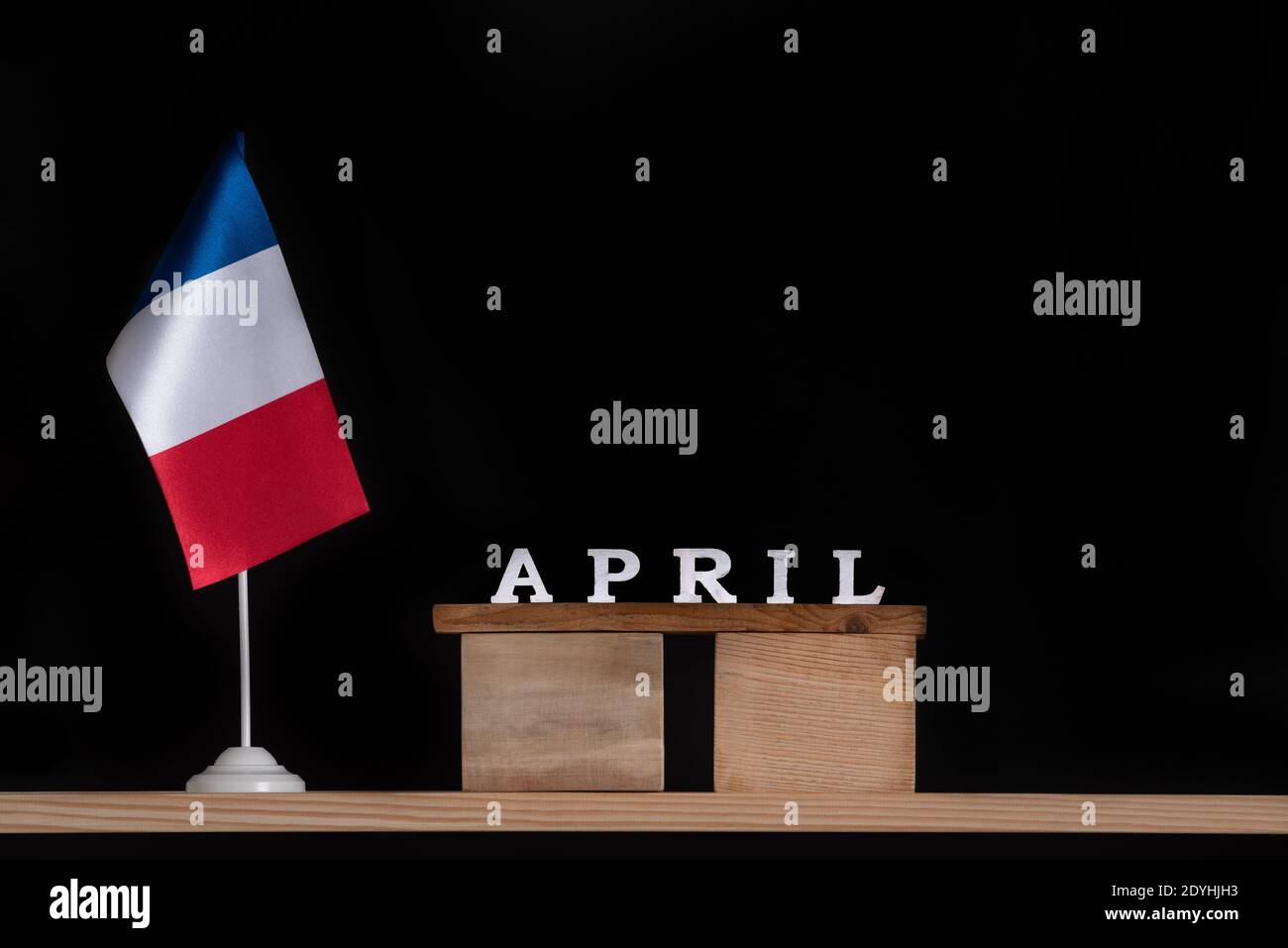 Wooden calendar of April with table French flag on black background ...