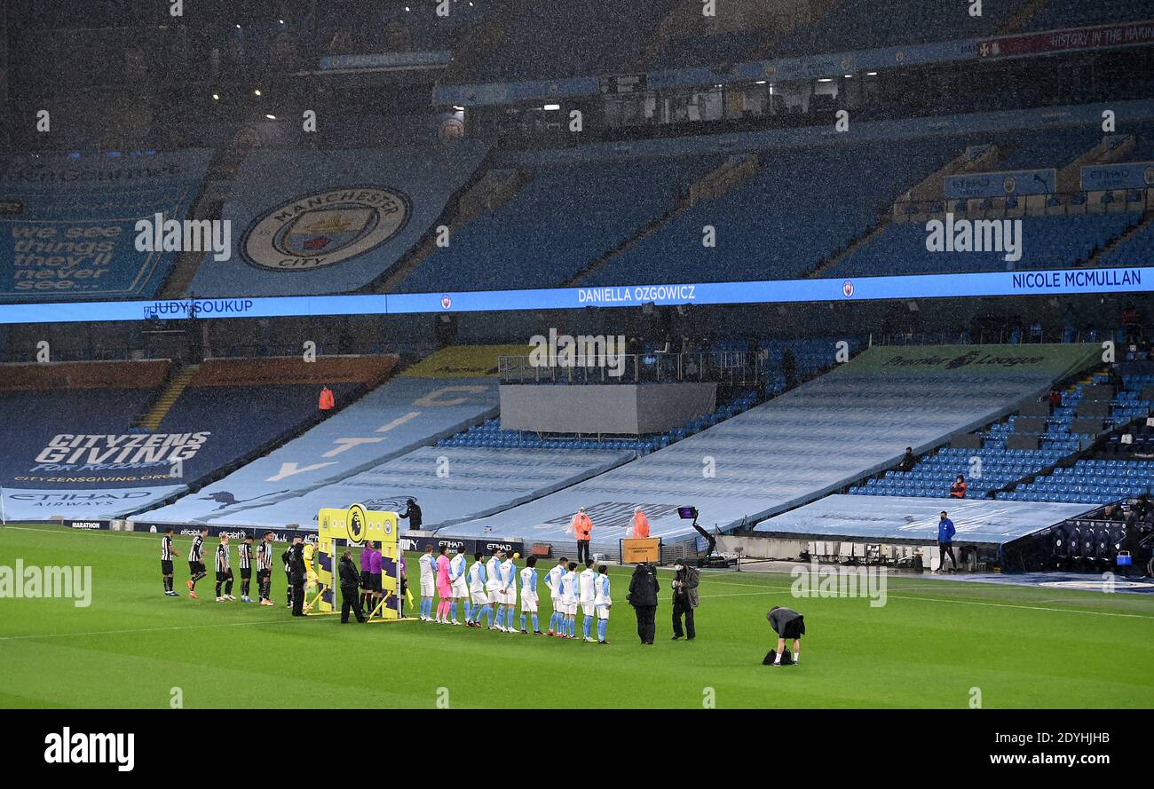 Manchester City and Newcastle United line up in front of empty stands ...