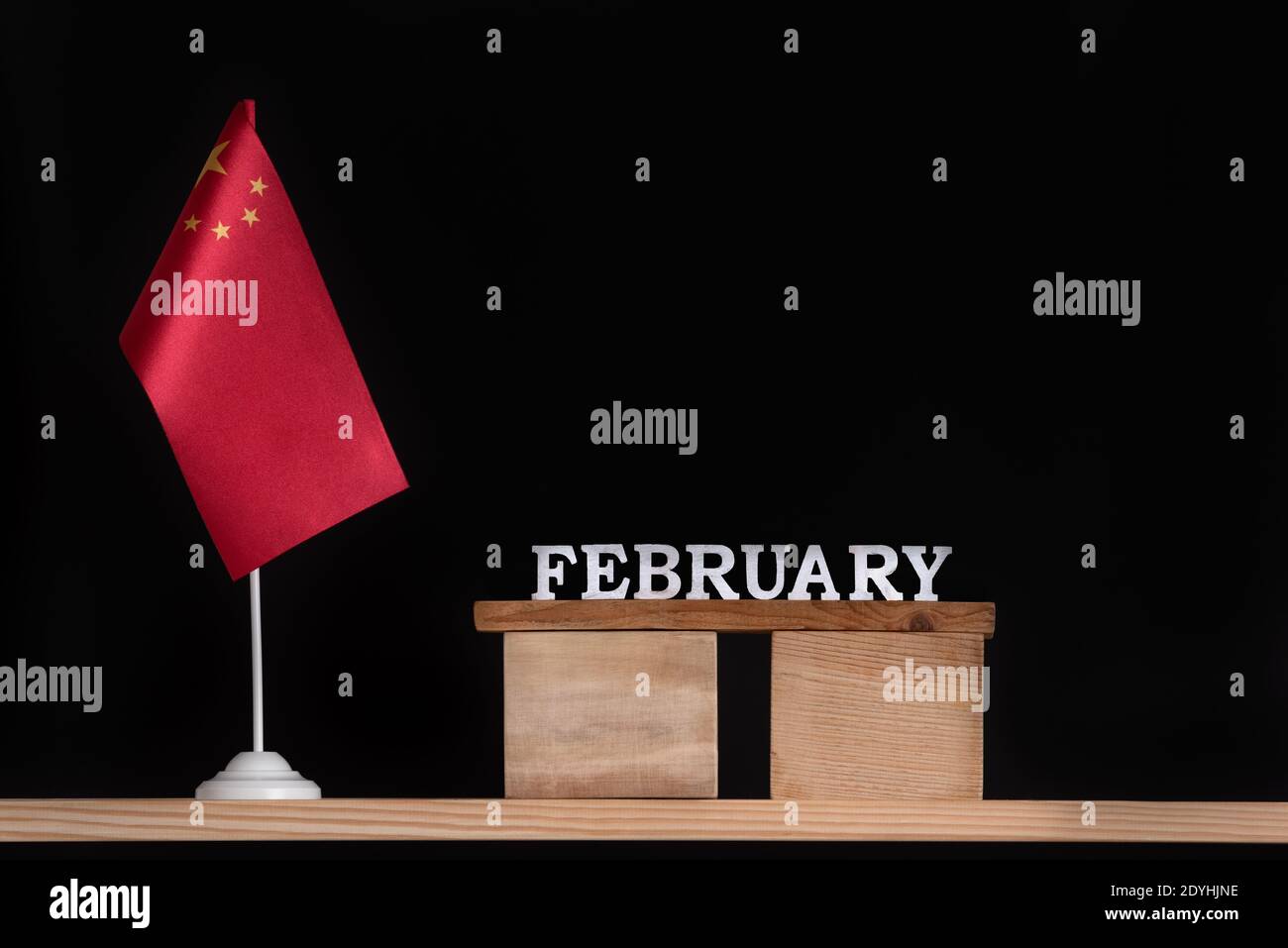 Wooden calendar of February with Chinese flag on black background ...