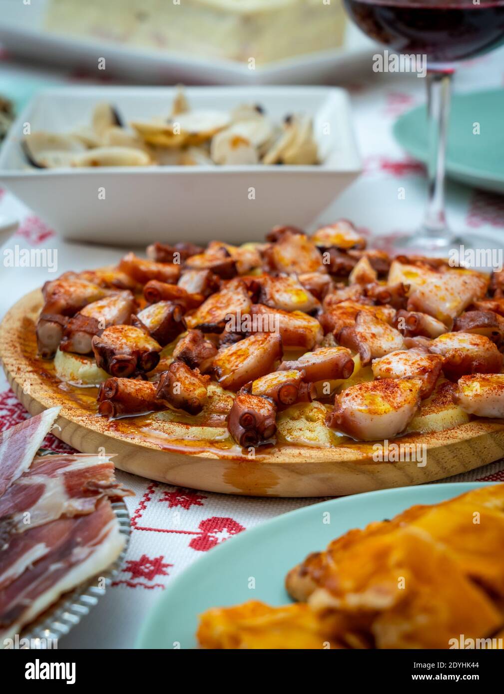 A vertical shot of fried octopus pieces with sauce and spice on a ...