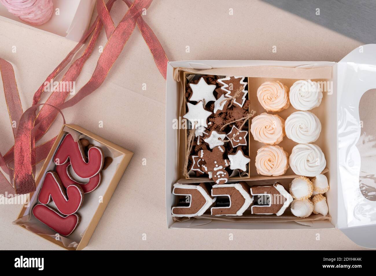 New Years sweets in gift wrapping. Tasty glazed painted cookies and ...