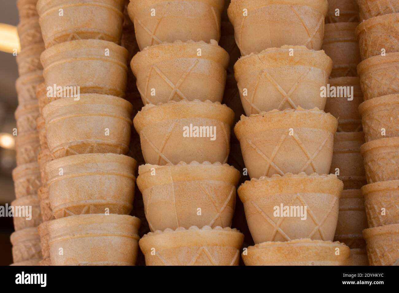 A low angle view of multiple ice cream cones stacked inside of each ...