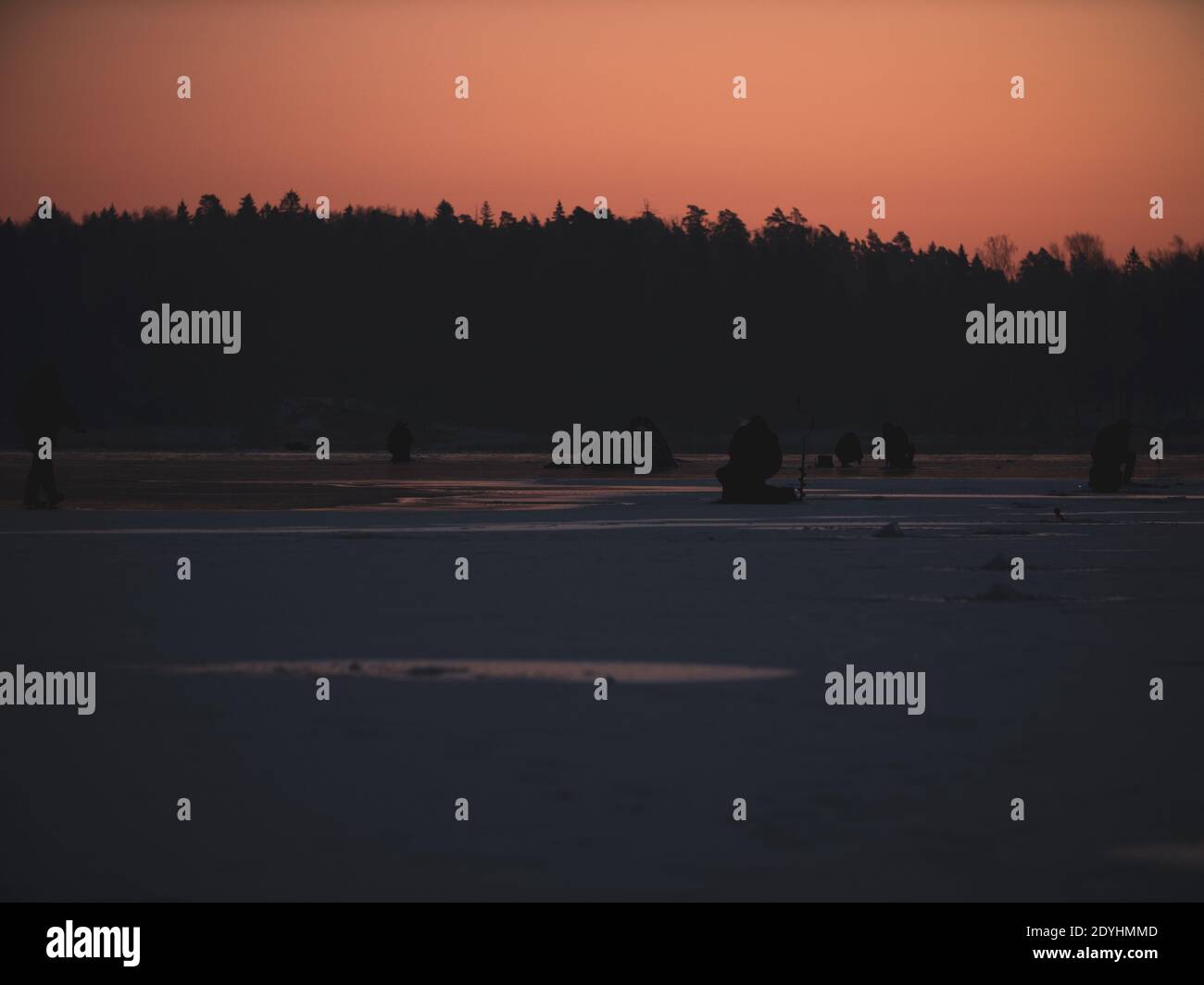 winter fishing with fisher on sanset Stock Photo - Alamy