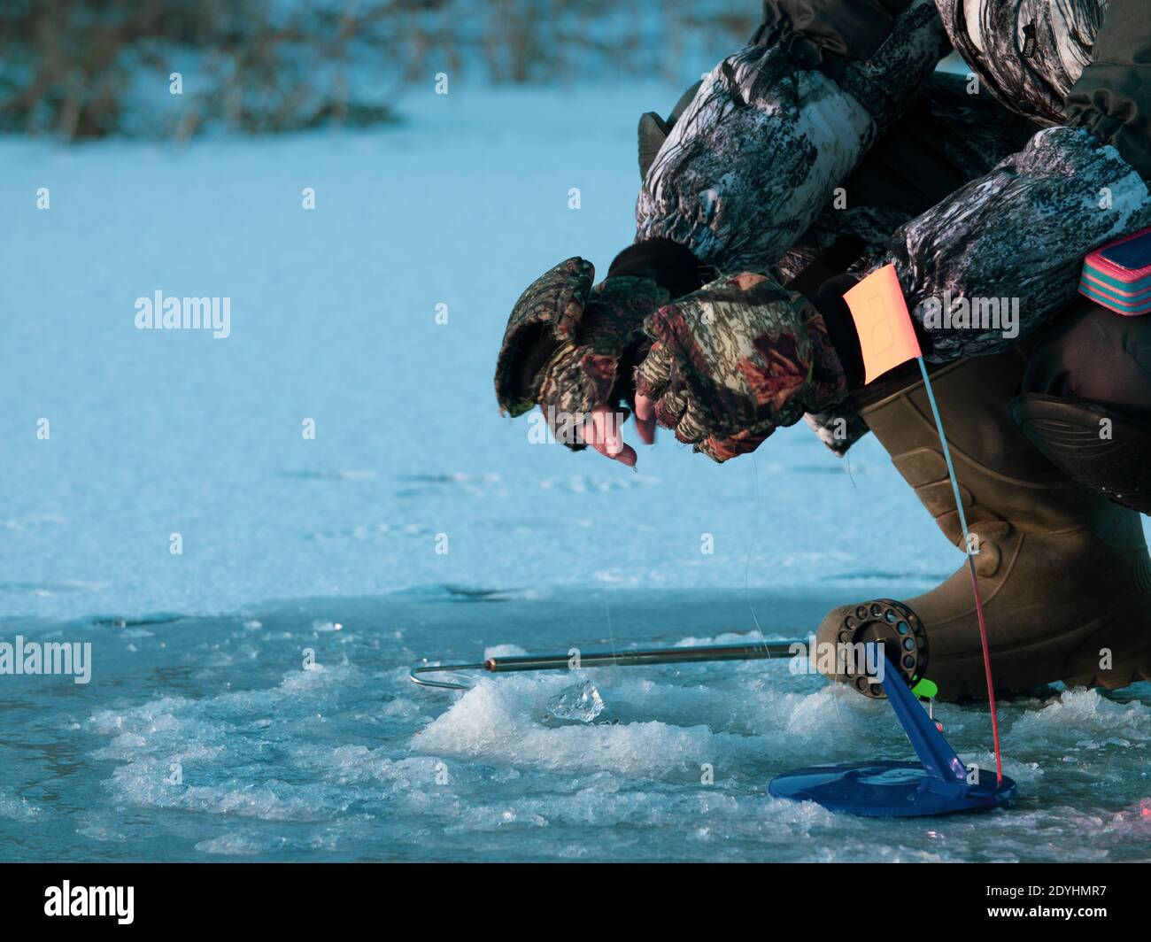 winter fishing with fisher Stock Photo - Alamy