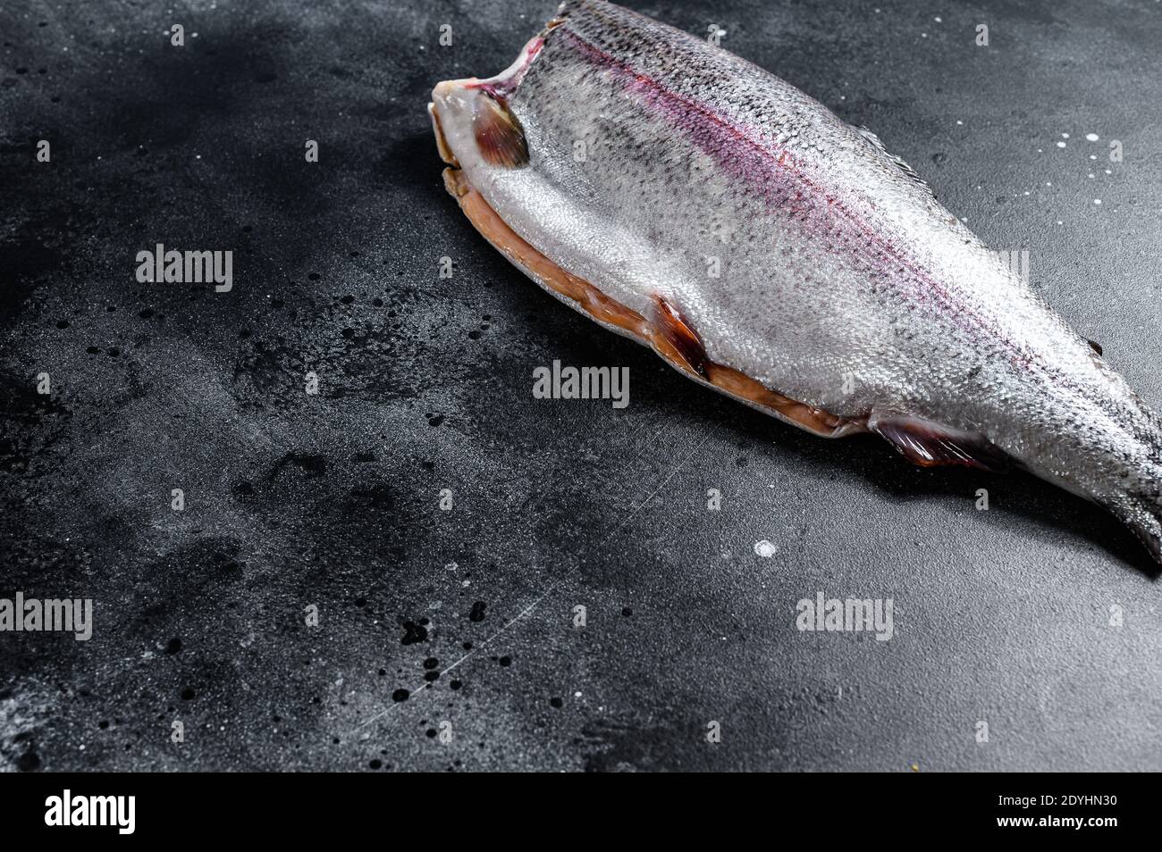 Fresh whole trout fishes. Black background. Top view. Copy space Stock ...