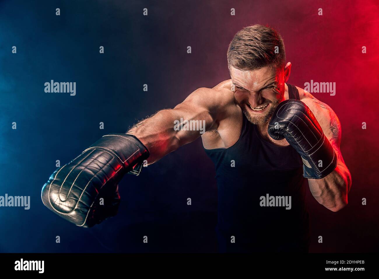 Bearded tattooed sportsman muay thai boxer in black undershirt and ...