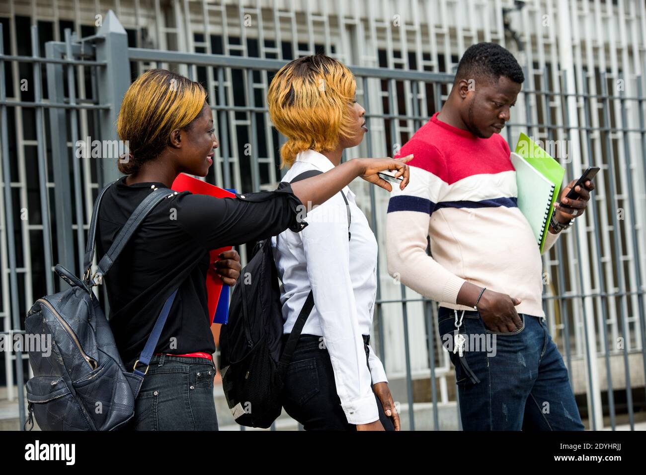 group of students standing outside the university building.Group of ...