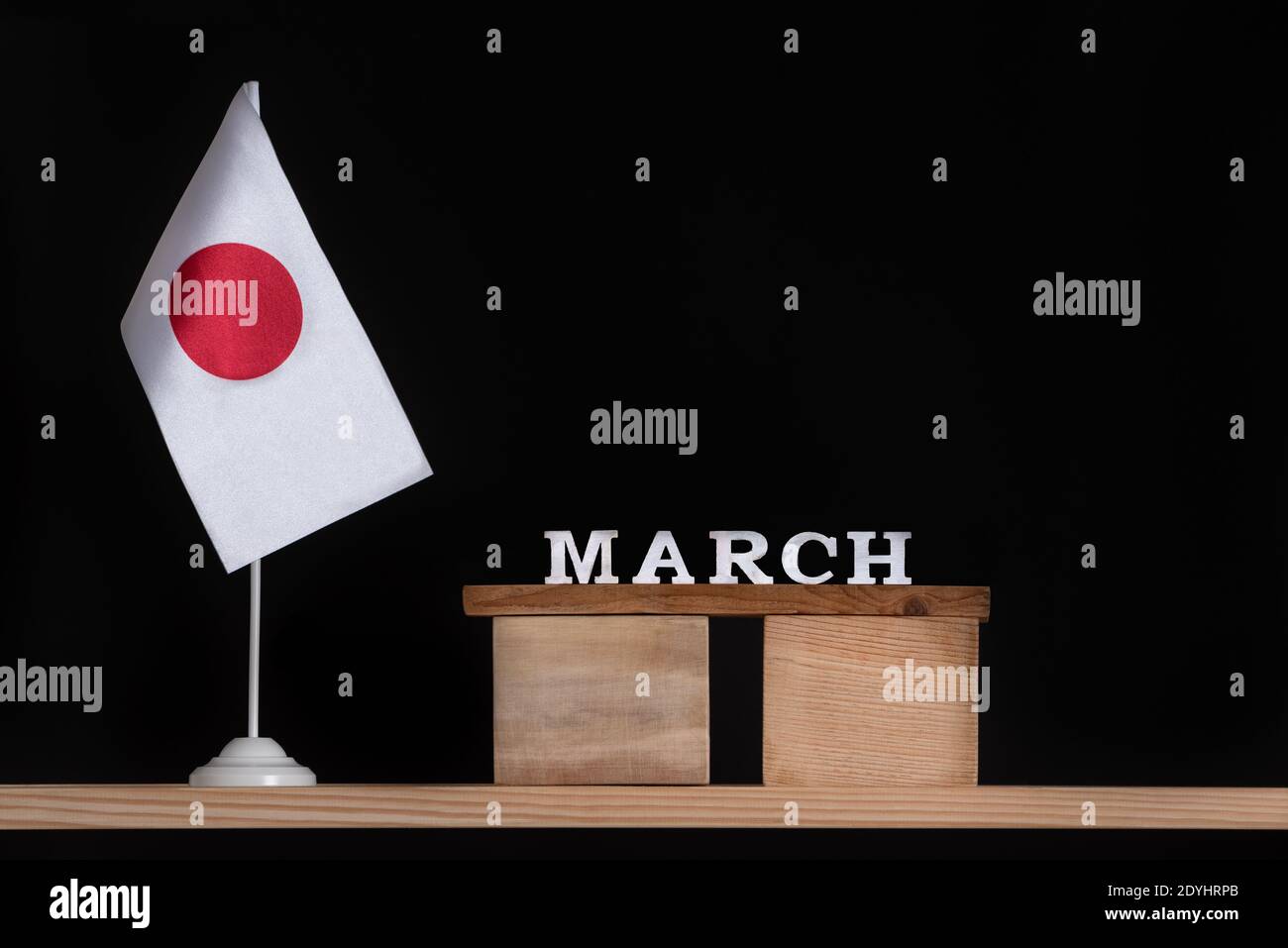Wooden calendar of March with Japan flag on black background. Dates of ...