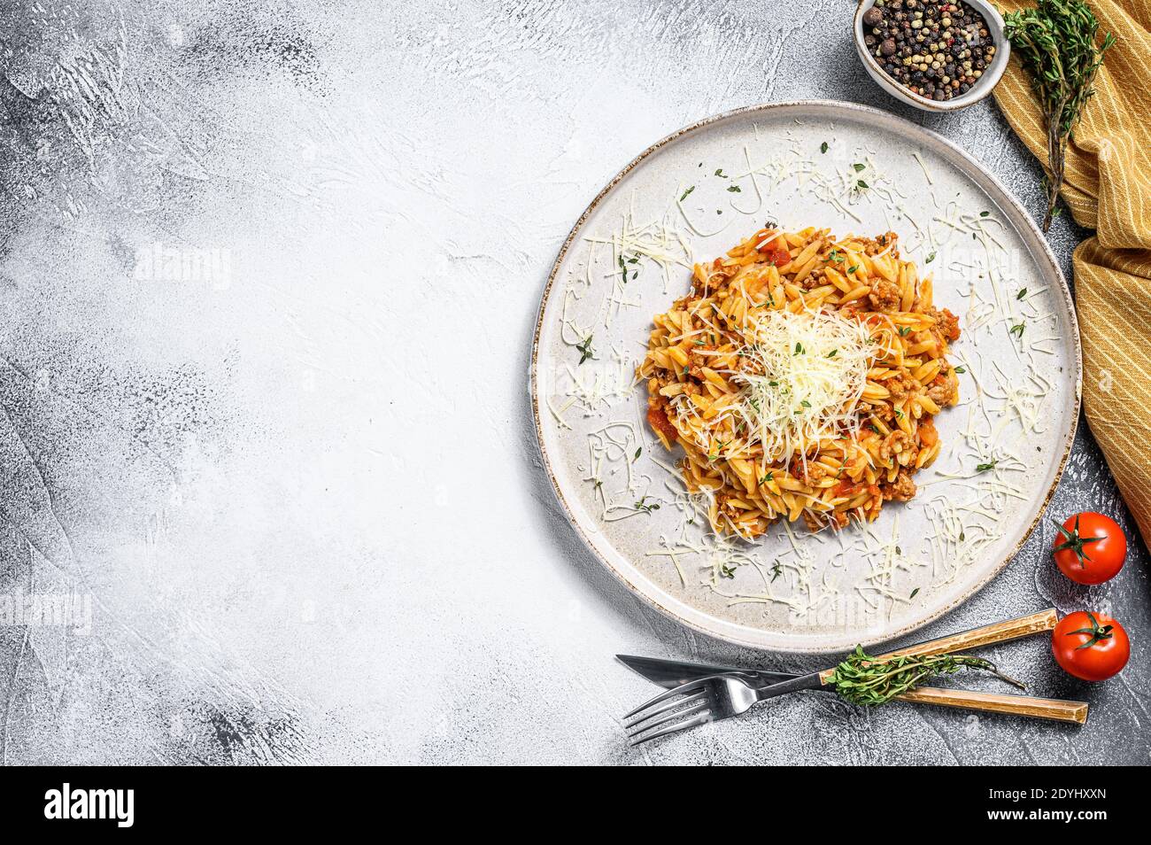 Bolognese pasta, risone with ground beef. White background. Top view ...