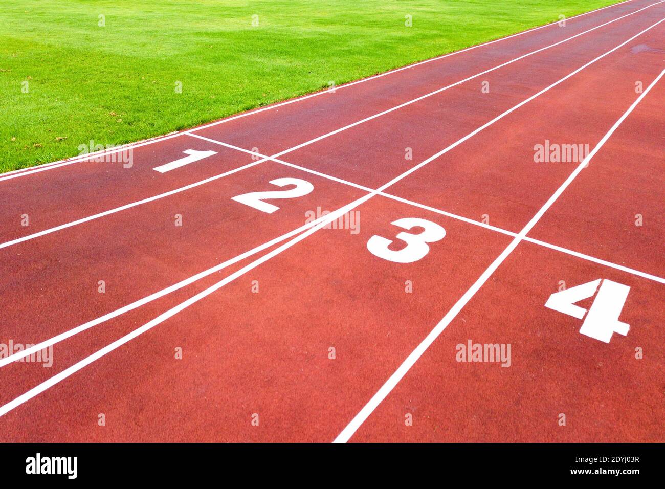 Aerial view of sports stadium with red running tracks with numbers on ...