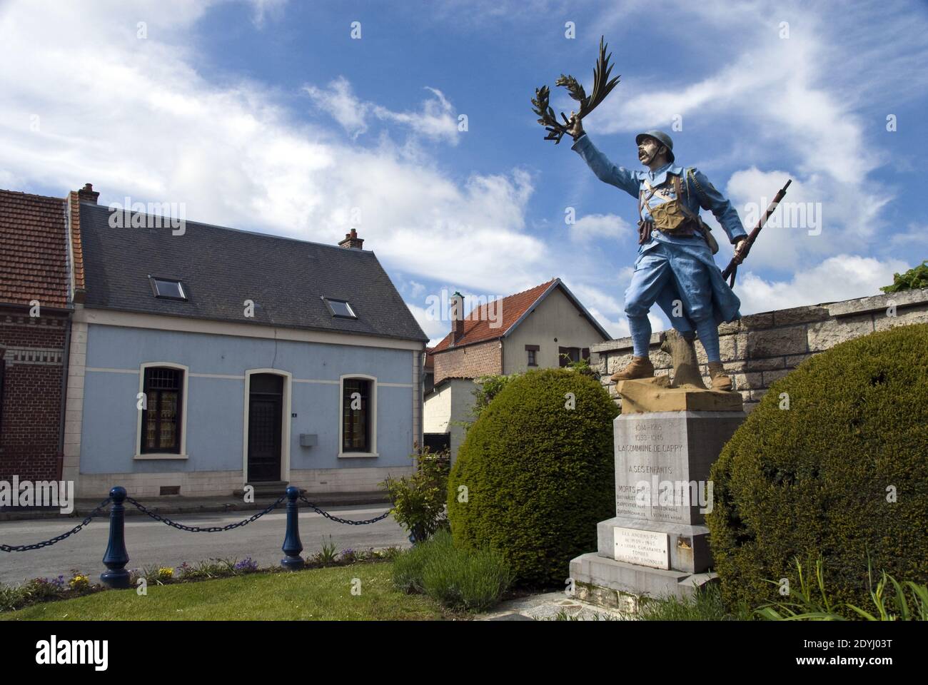 A colorfully painted metal statue of a WW I French soldier stands as a ...