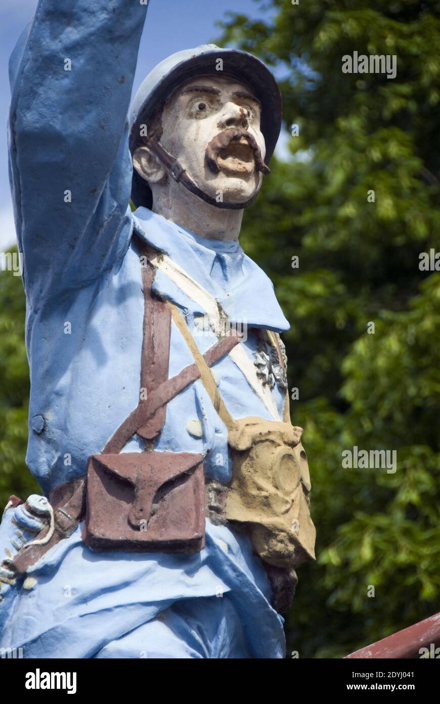 A colorfully painted metal statue of a WW I French soldier stands as a ...