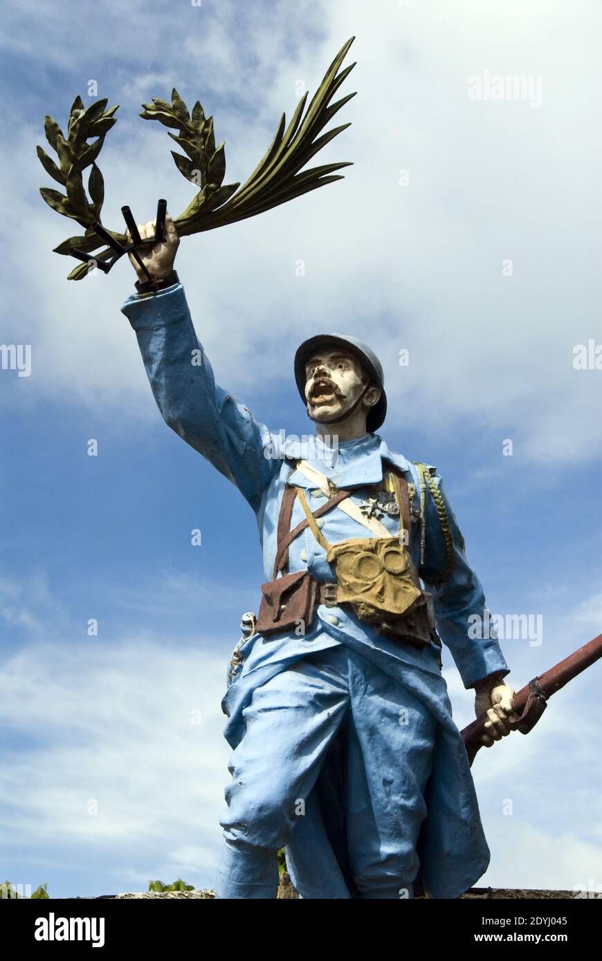 A colorfully painted metal statue of a WW I French soldier stands as a ...