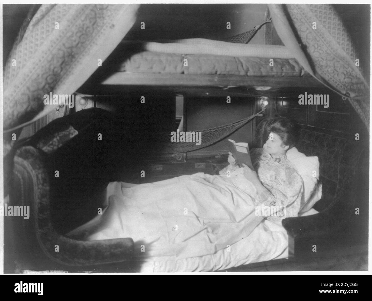 Lady reading in berth with curtains down Stock Photo - Alamy