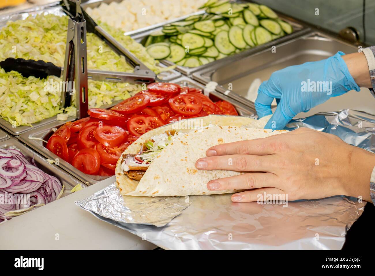 Durum Kebab is being prepared in a local pizza and gyros restaurant ...