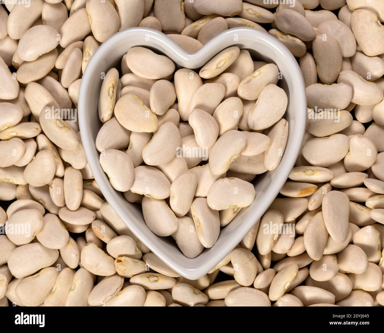 Large lima beans in a heart shaped bowl background and texture. Top ...