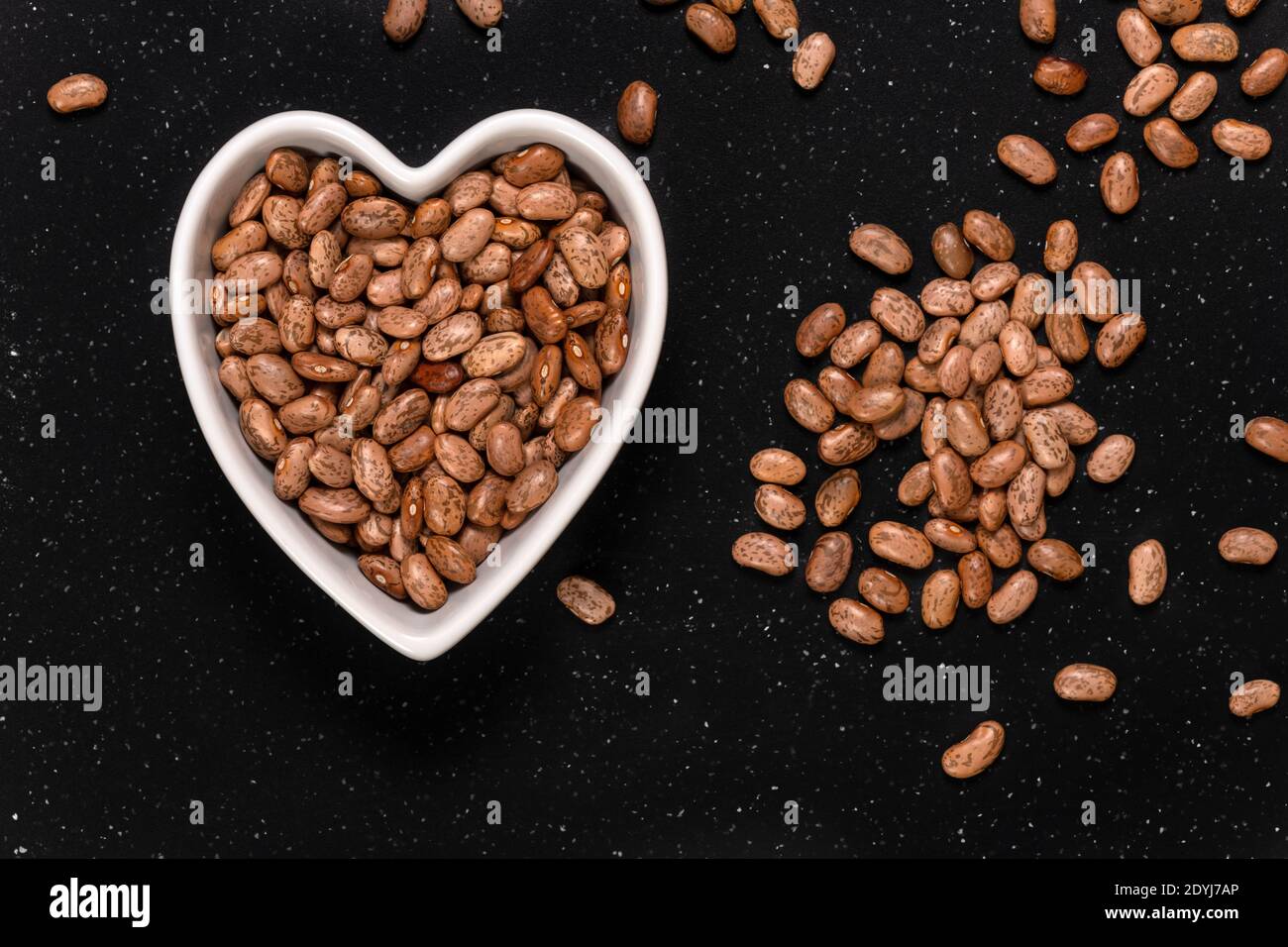 Pinto beans or speckled beans in a heart shaped bowl background and ...