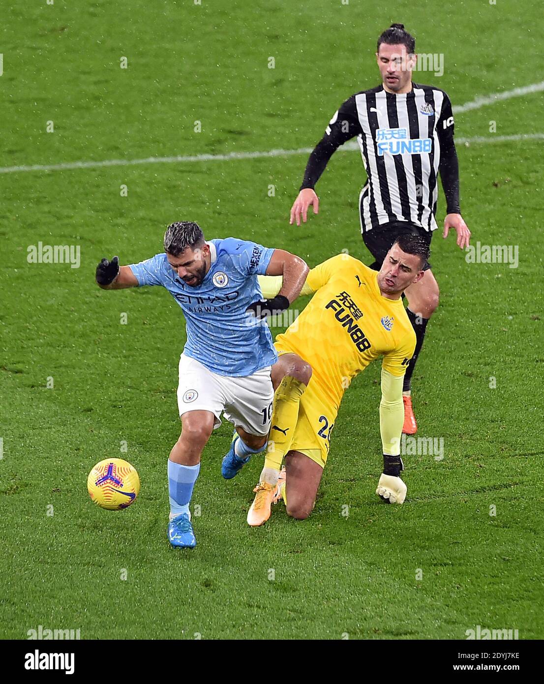 Manchester City's Sergio Aguero goes down under the challenge from ...