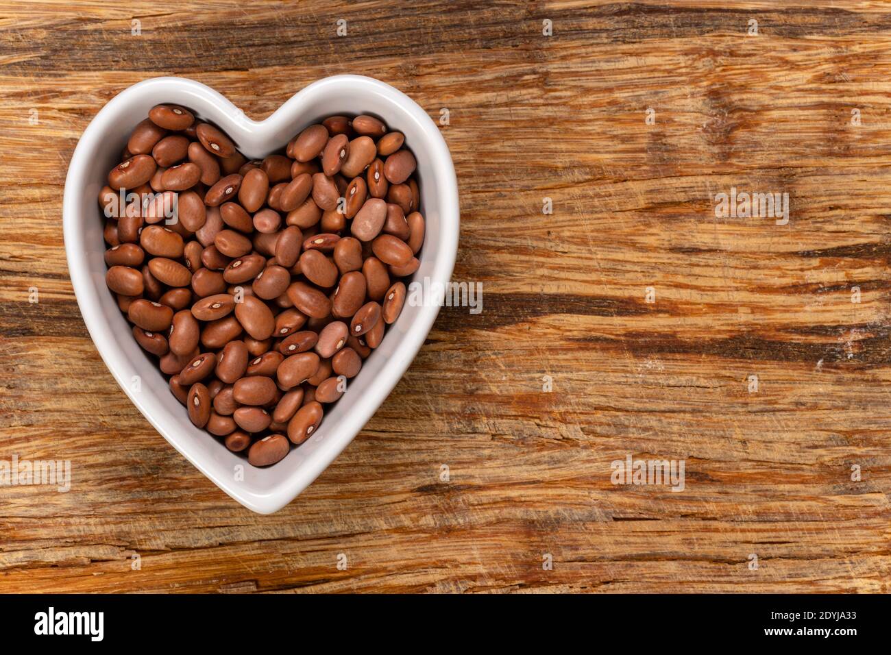 Pink kidney beans in a heart shaped bowl background and texture. Top ...