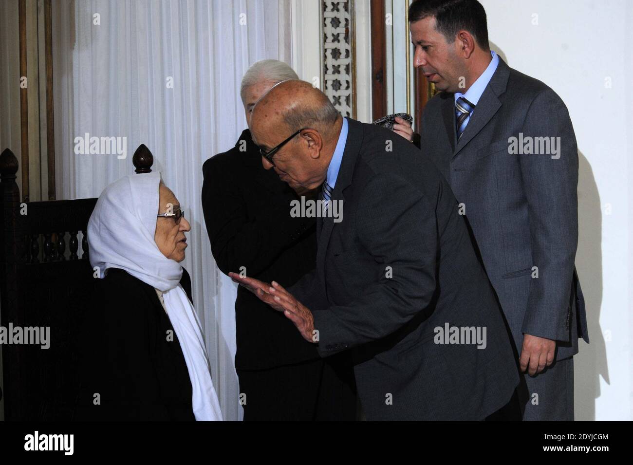 Ali Kafi's wife pays her respects in front of the coffin of Algeria's ...