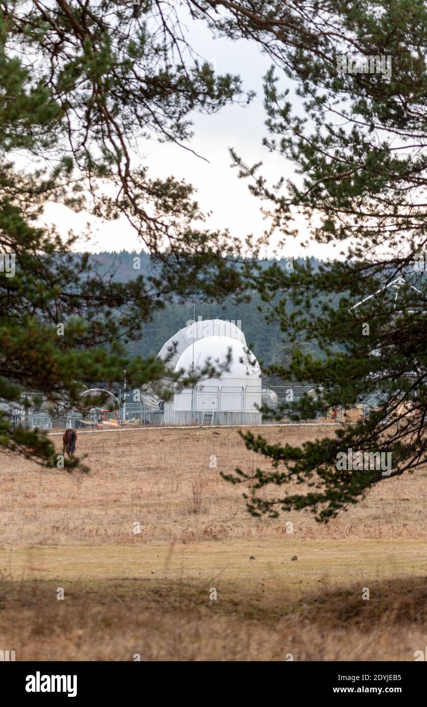 Big satellite dish antennas hidden in green pine tree forest ... Big satellite dish antennas hidden in green pine tree forest ...